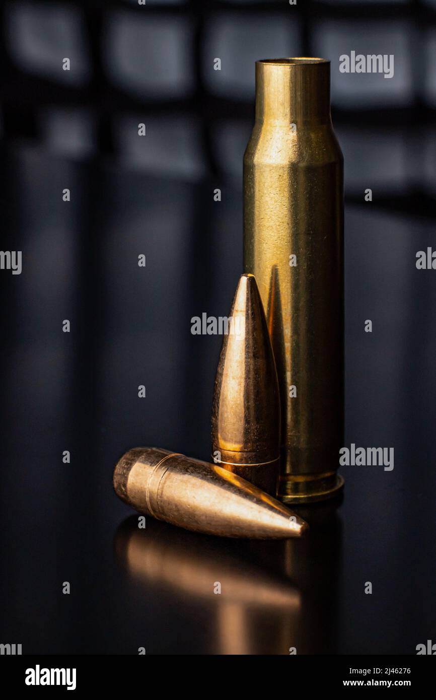 Bullet isolated on black background with reflexion. Rifle bullets close ...