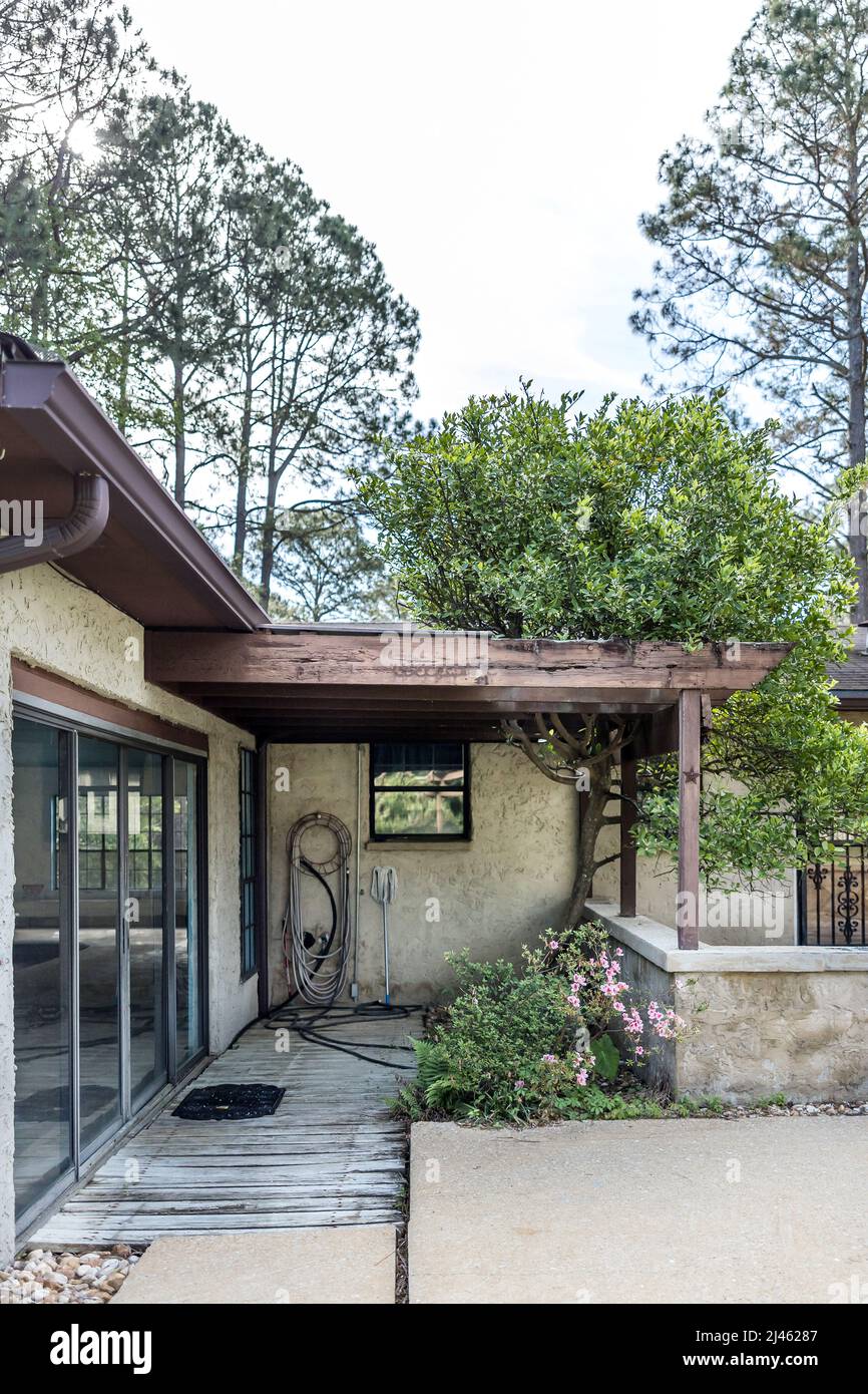 Rear angle view of brown spanish style stucco and cinder block 1970's ...
