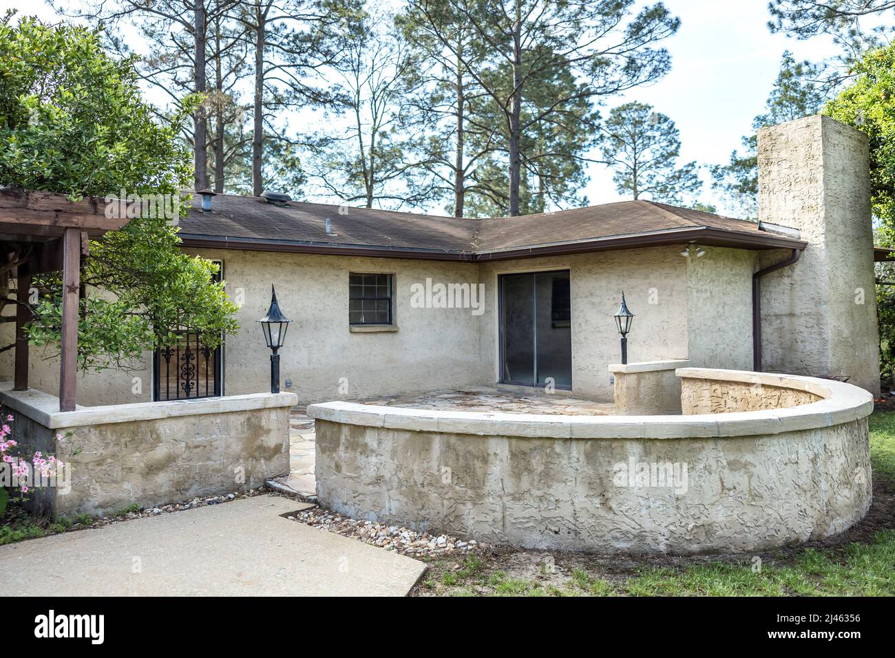 Rear angle view of brown spanish style stucco and cinder block 1970's ...