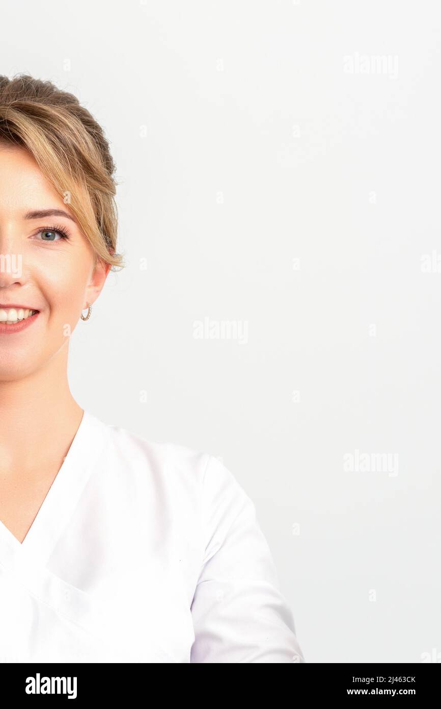 Close-up portrait of young smiling female caucasian healthcare worker ...
