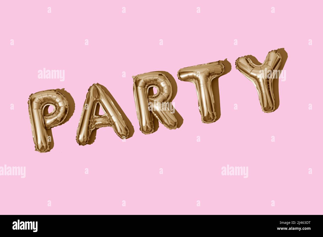 golden letter-shaped balloons forming the word party on a pink ...
