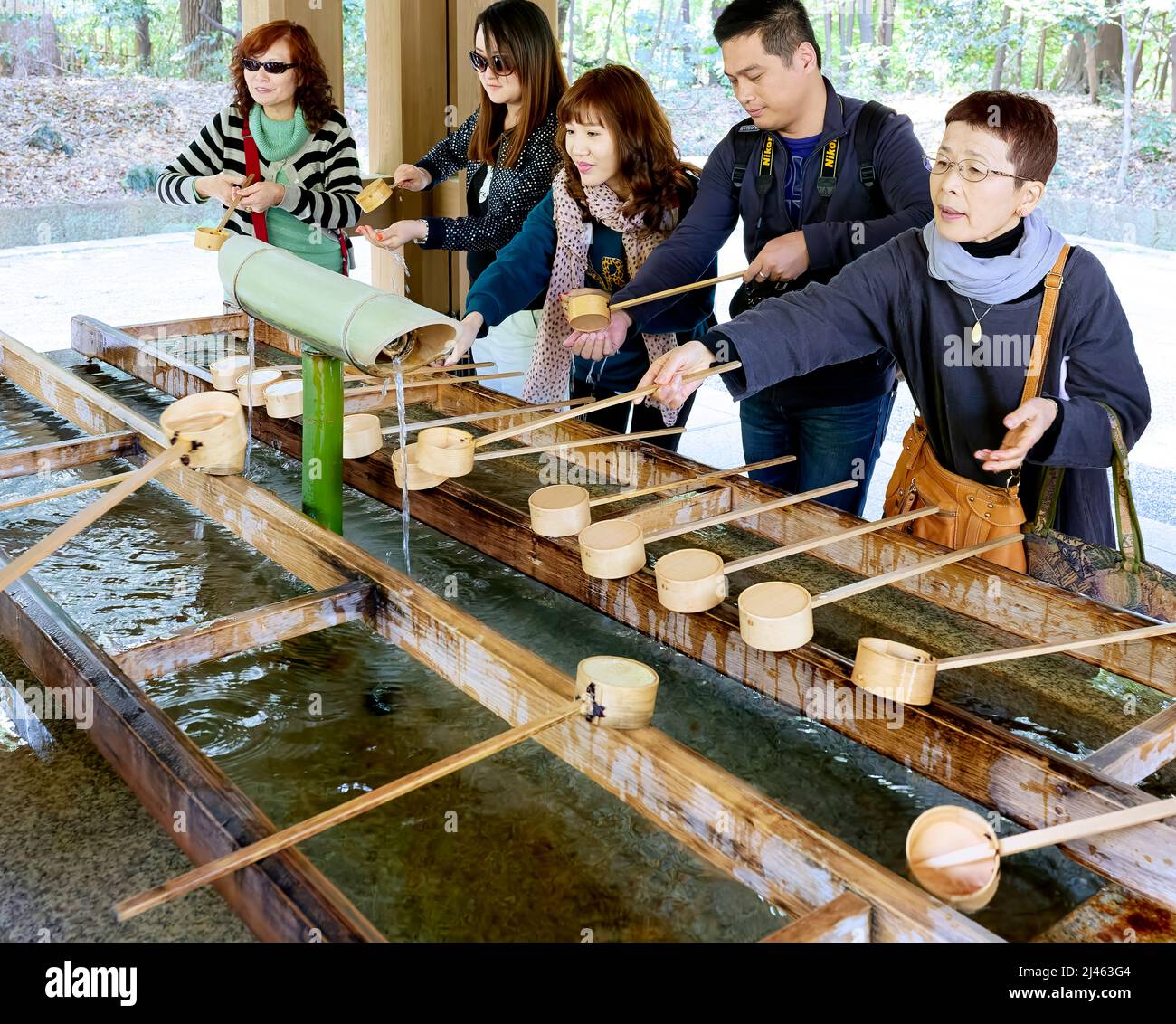 Japan. Tokyo. Cleaning hands and purification at the entrance of Meiji ...