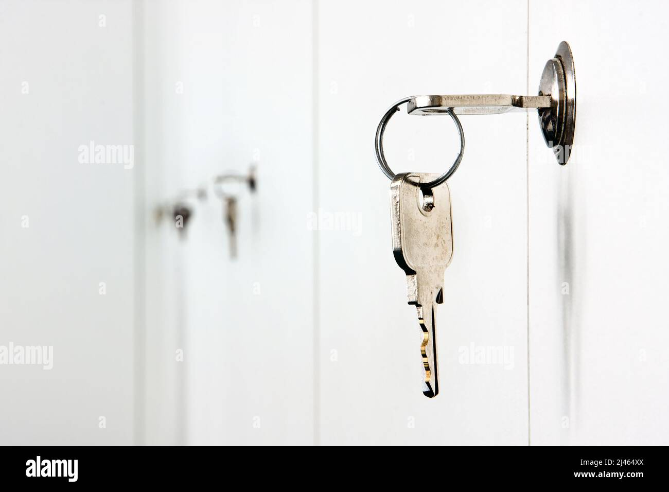 Keys on a row of office cabinets with company files Stock Photo - Alamy