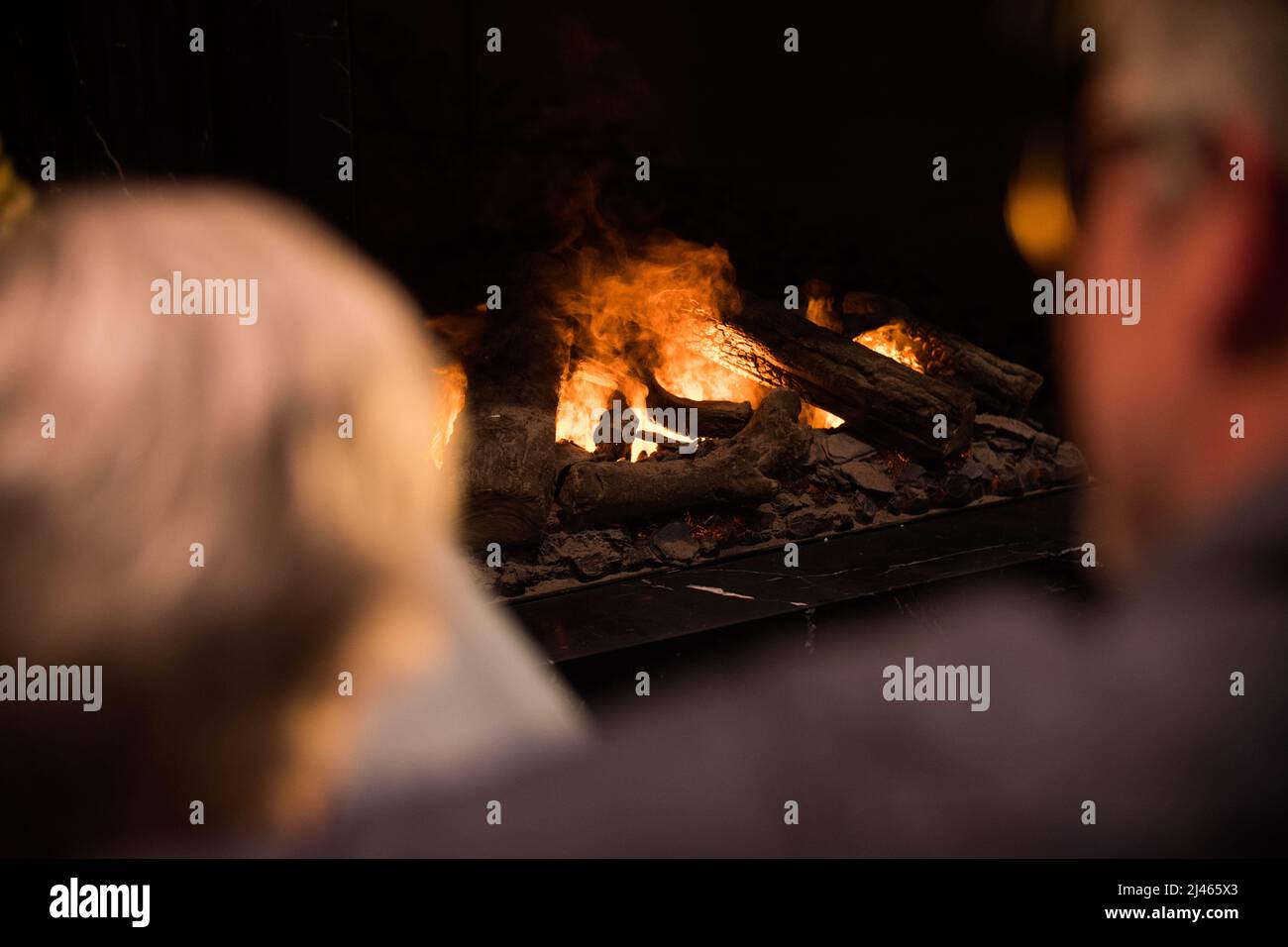 Romantic couple relaxing in front of the fireplace Stock Photo - Alamy