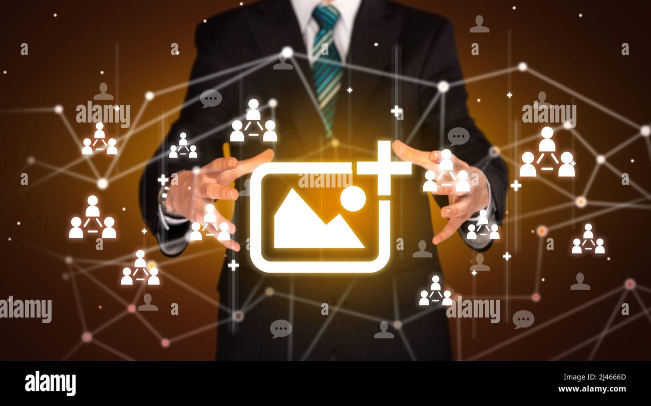 Hand holding social media icons Stock Photo - Alamy