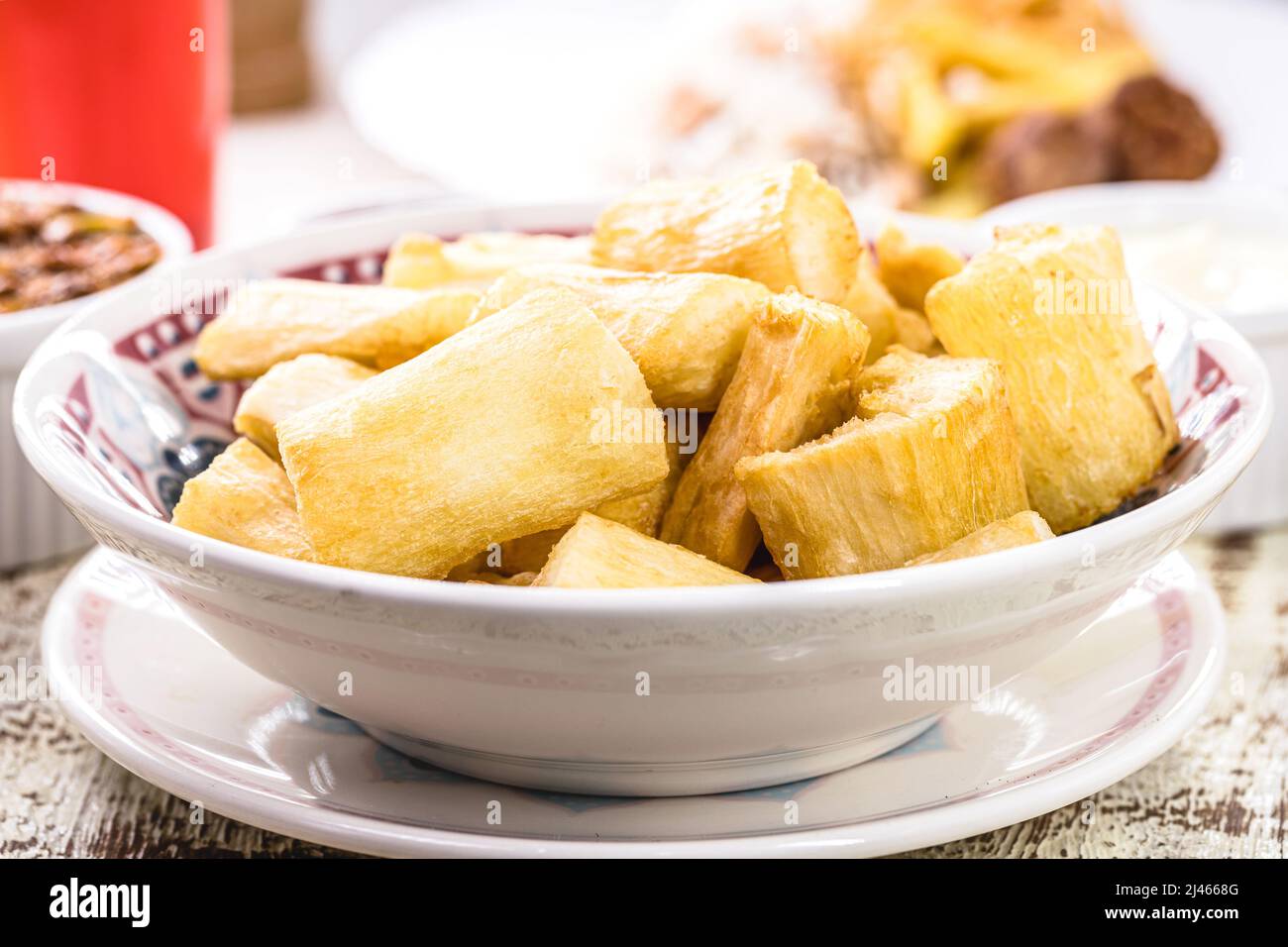 fried cassava with vegetables and sauces, a typical Brazilian snack ...