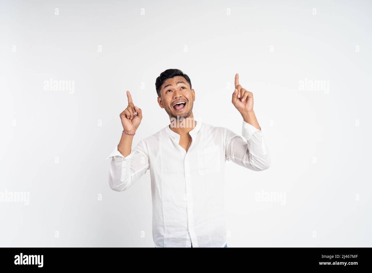 excited asian young man with two fingers pointing up Stock Photo - Alamy