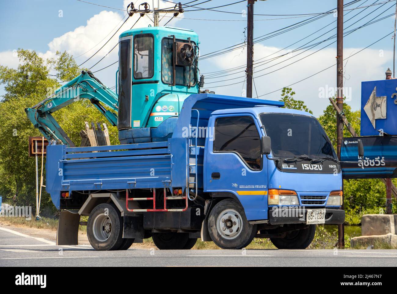 BANGKOK, THAILAND, MARCH 27 2022, A truck loaded with digger ride on a ...