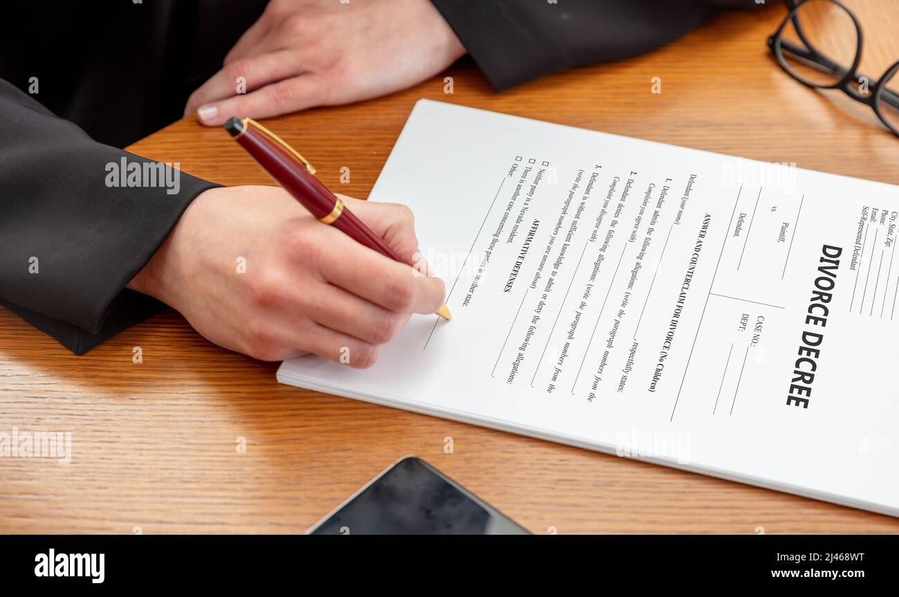 DIVORCE DECREE. Woman signing the paper, Lawyer, notary office. Female ...