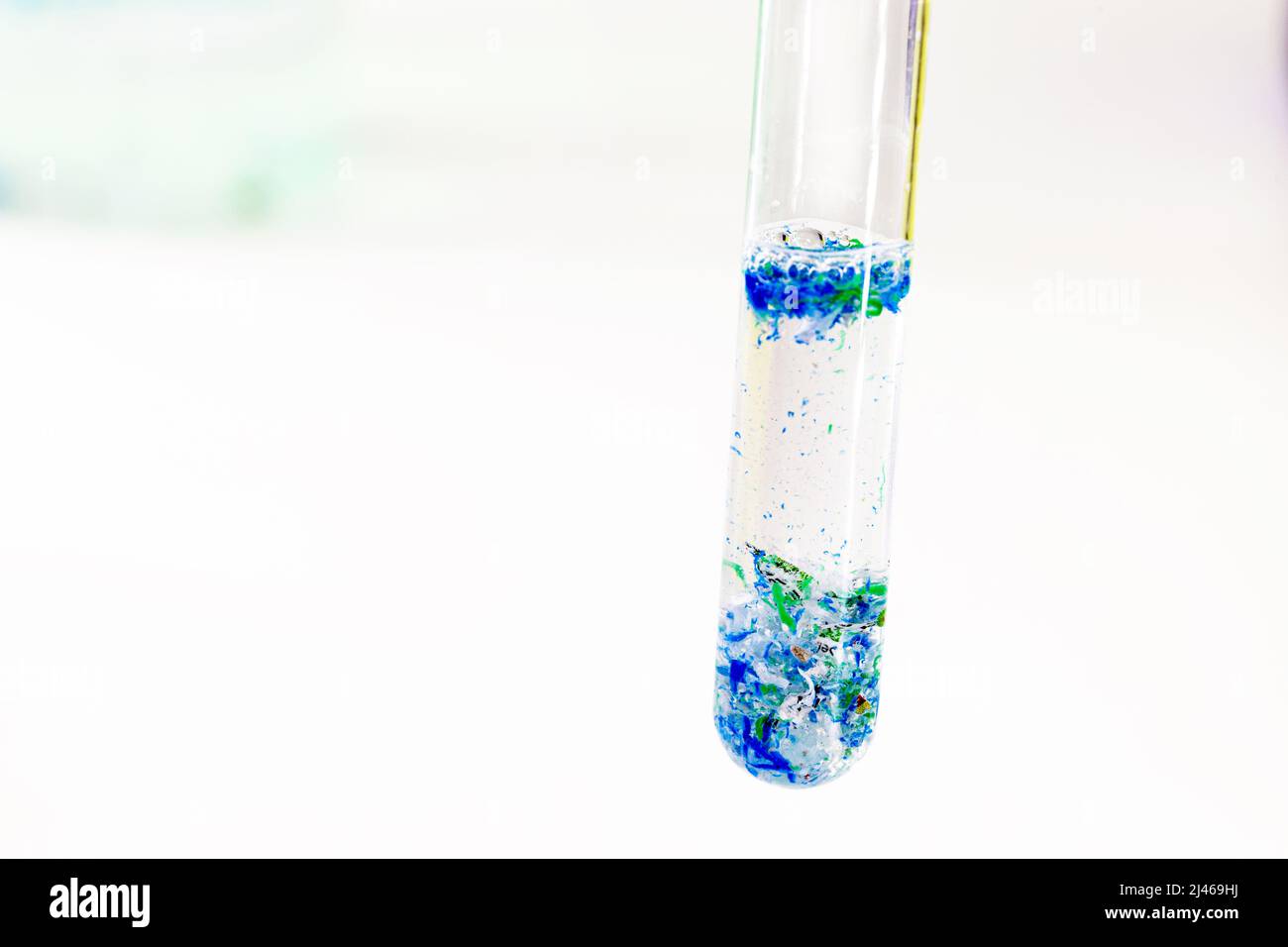close-up of test tube with polluted water and traces of plastic and ...