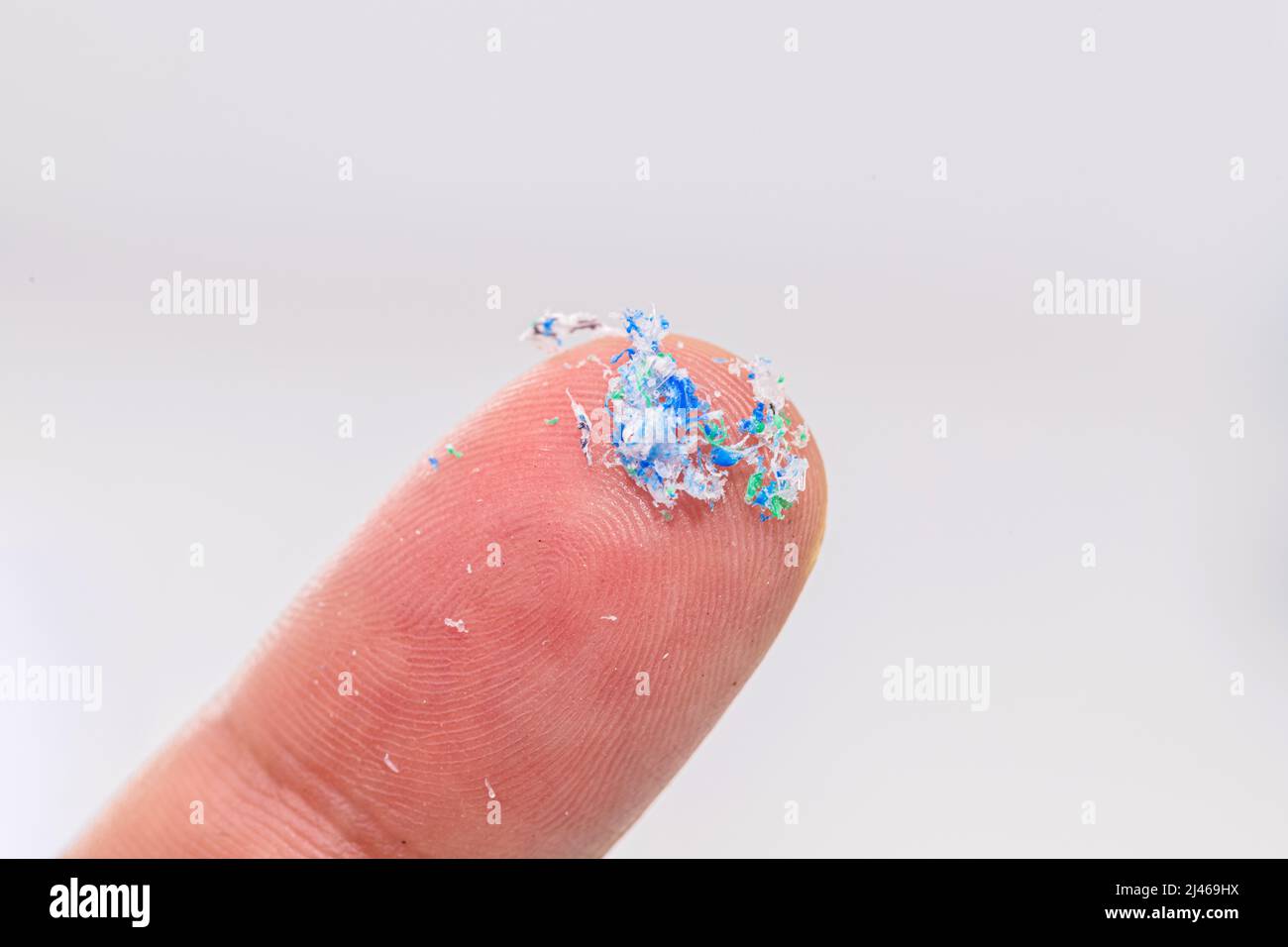 finger close-up with traces of plastic and microplastic, environmental ...