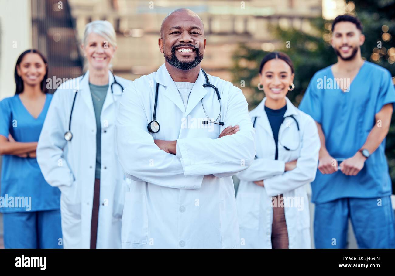 Your health is our priority. Shot of a group of doctors standing with ...