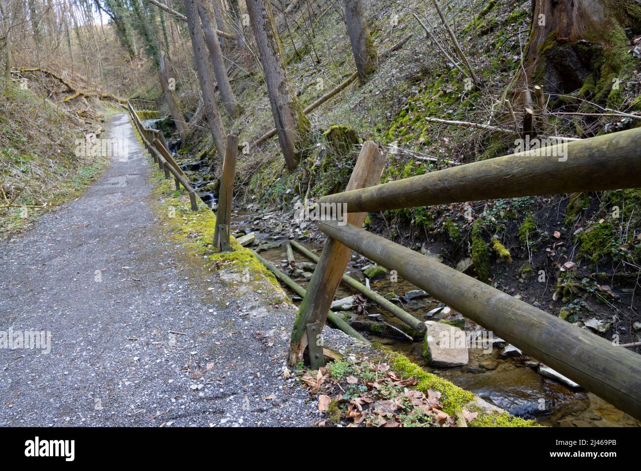 Broken wooden railing on the side of a pathway Stock Photo - Alamy