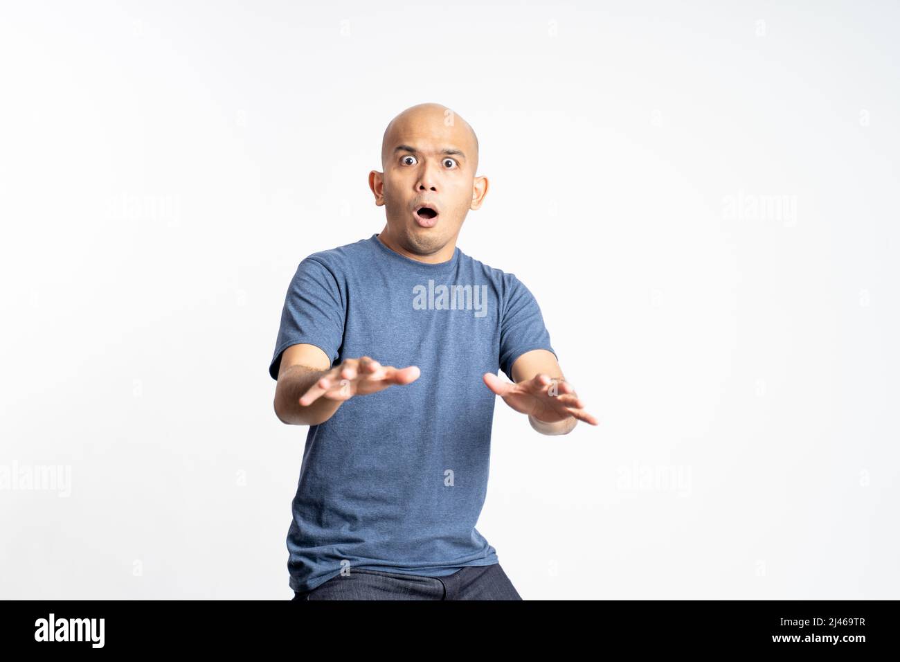 shocked bald man with bulging eyes expression Stock Photo - Alamy