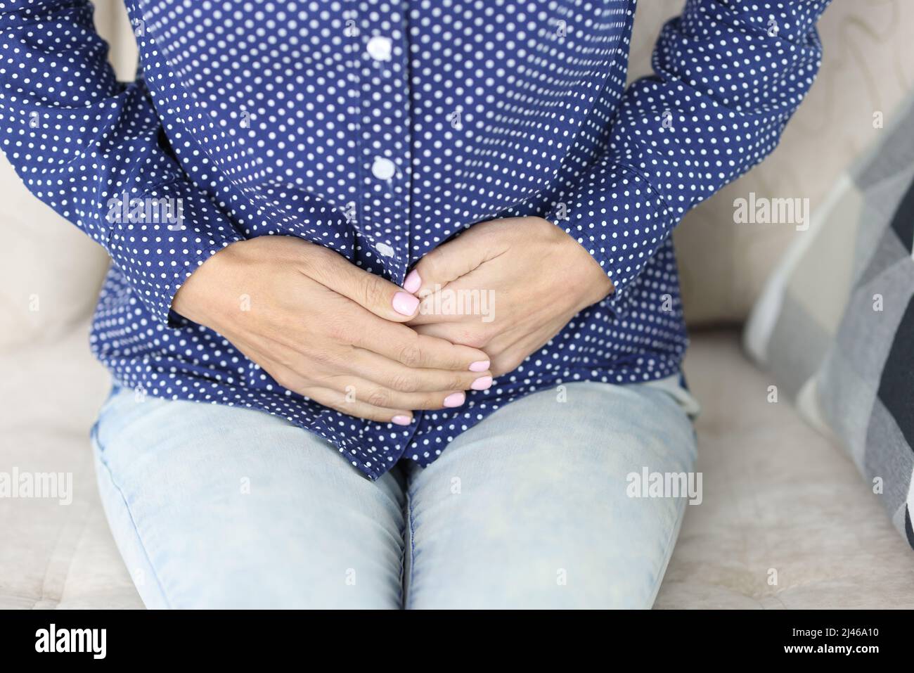 Women hands on stomach with painful spasms closeup Stock Photo - Alamy