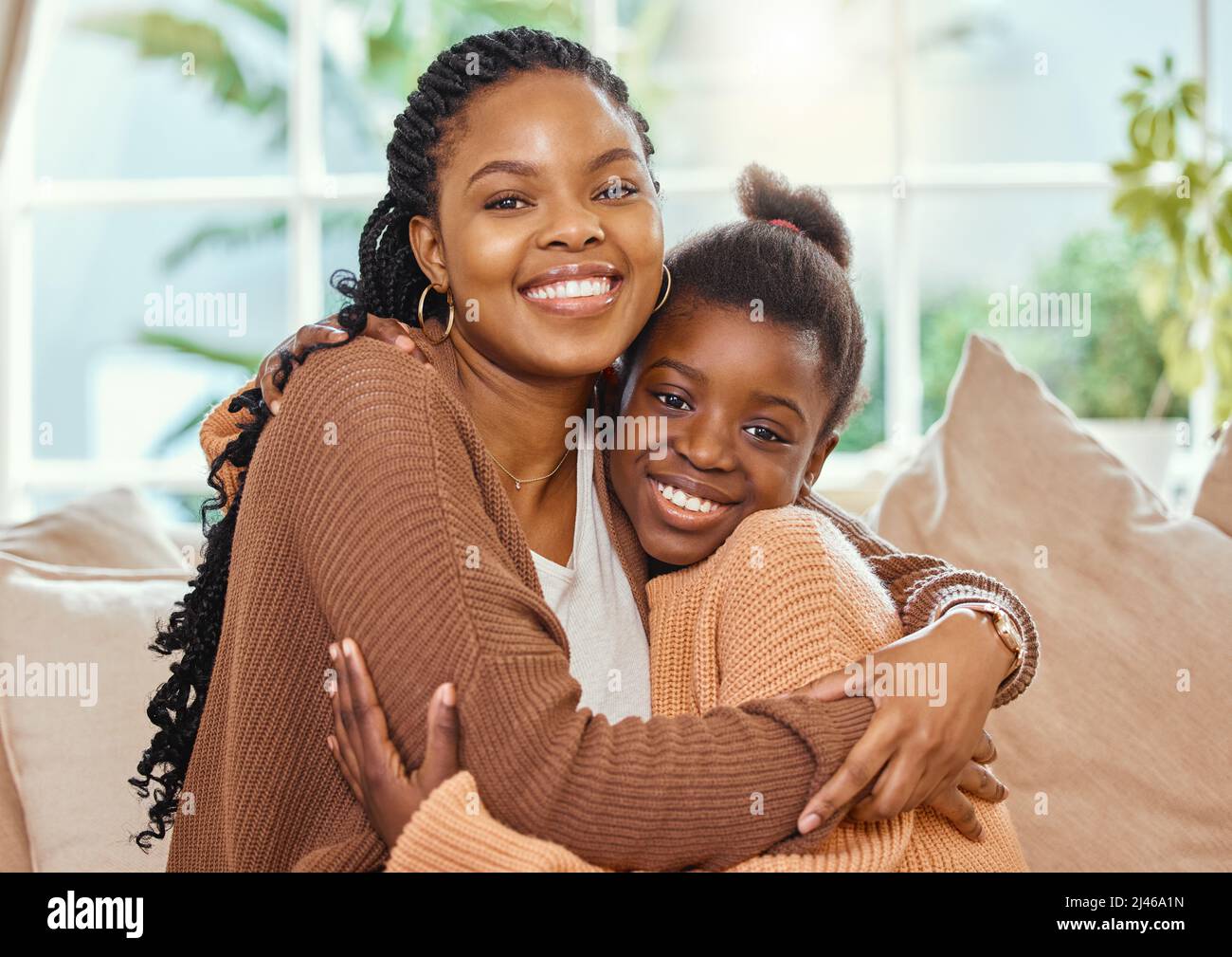The sweetest hugs ever. Shot of a young mother hugging her daughter ...