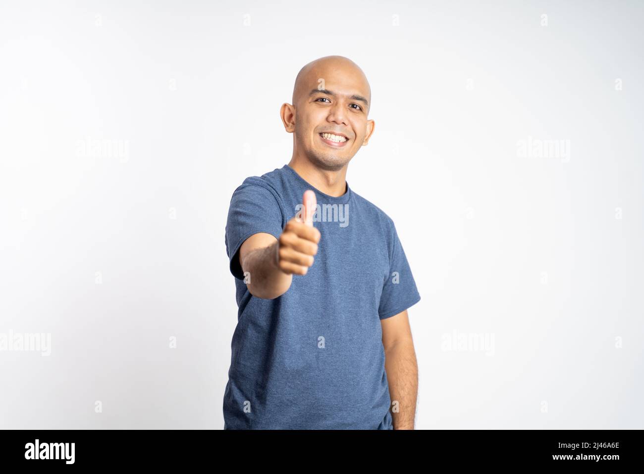 smiling asian bald man showing thumbs up while standing Stock Photo - Alamy