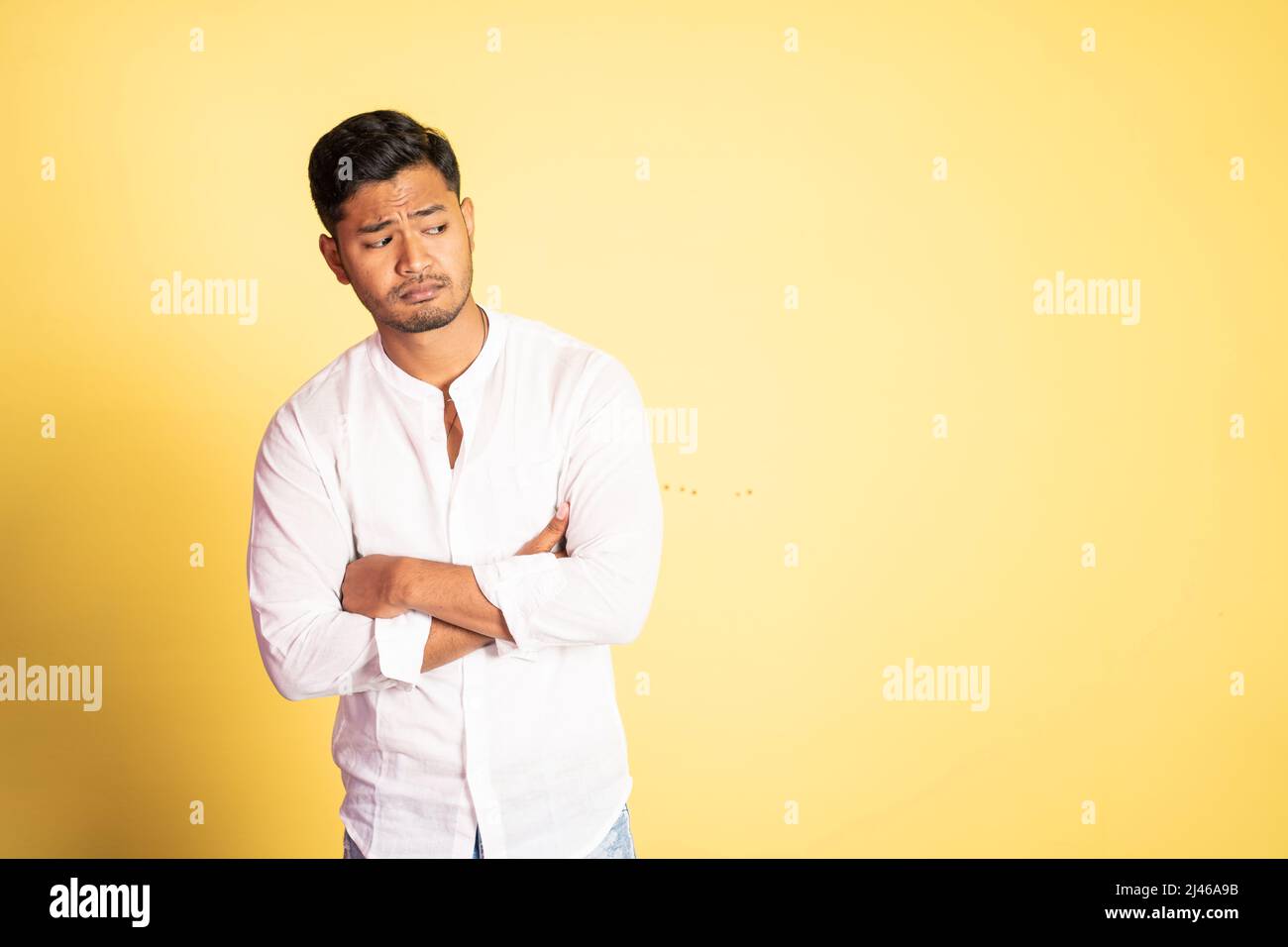 asian young man with bored expression with hands crossed Stock Photo ...
