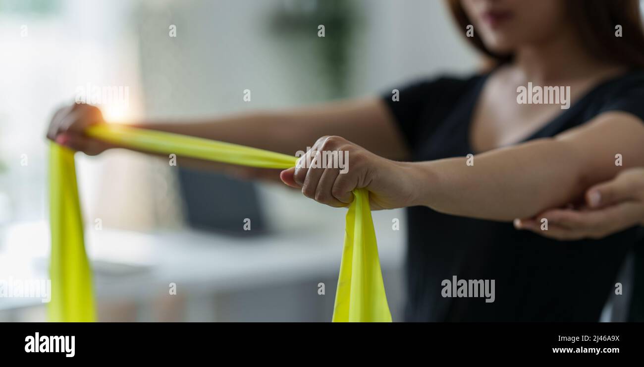 Doctor or Physiotherapist working examining treating using rubber Bands ...