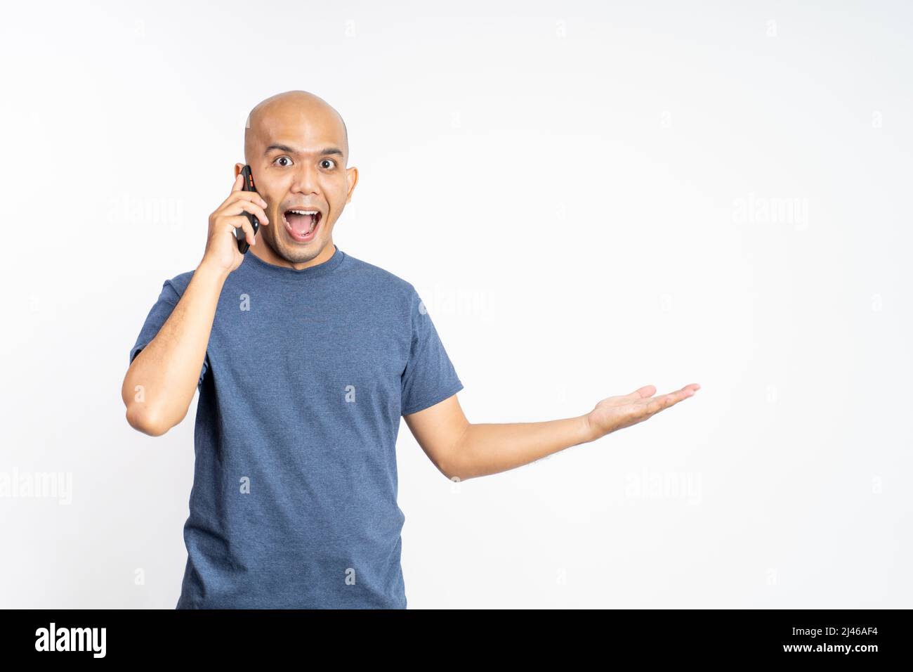 smiling bald man with serving something while making a call Stock Photo ...