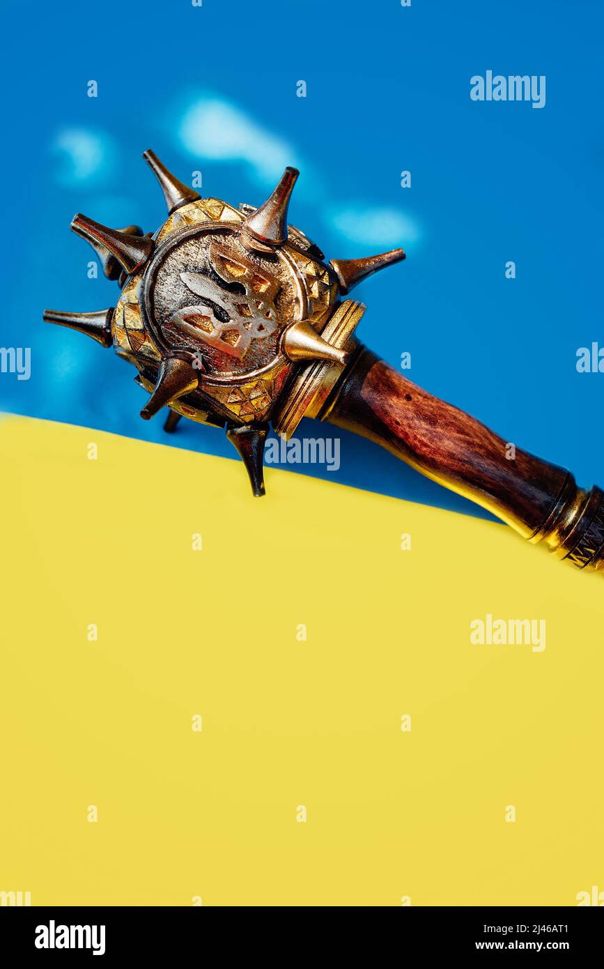 mace with emblem of Ukraine trident on blue and yellow national Flag of ...