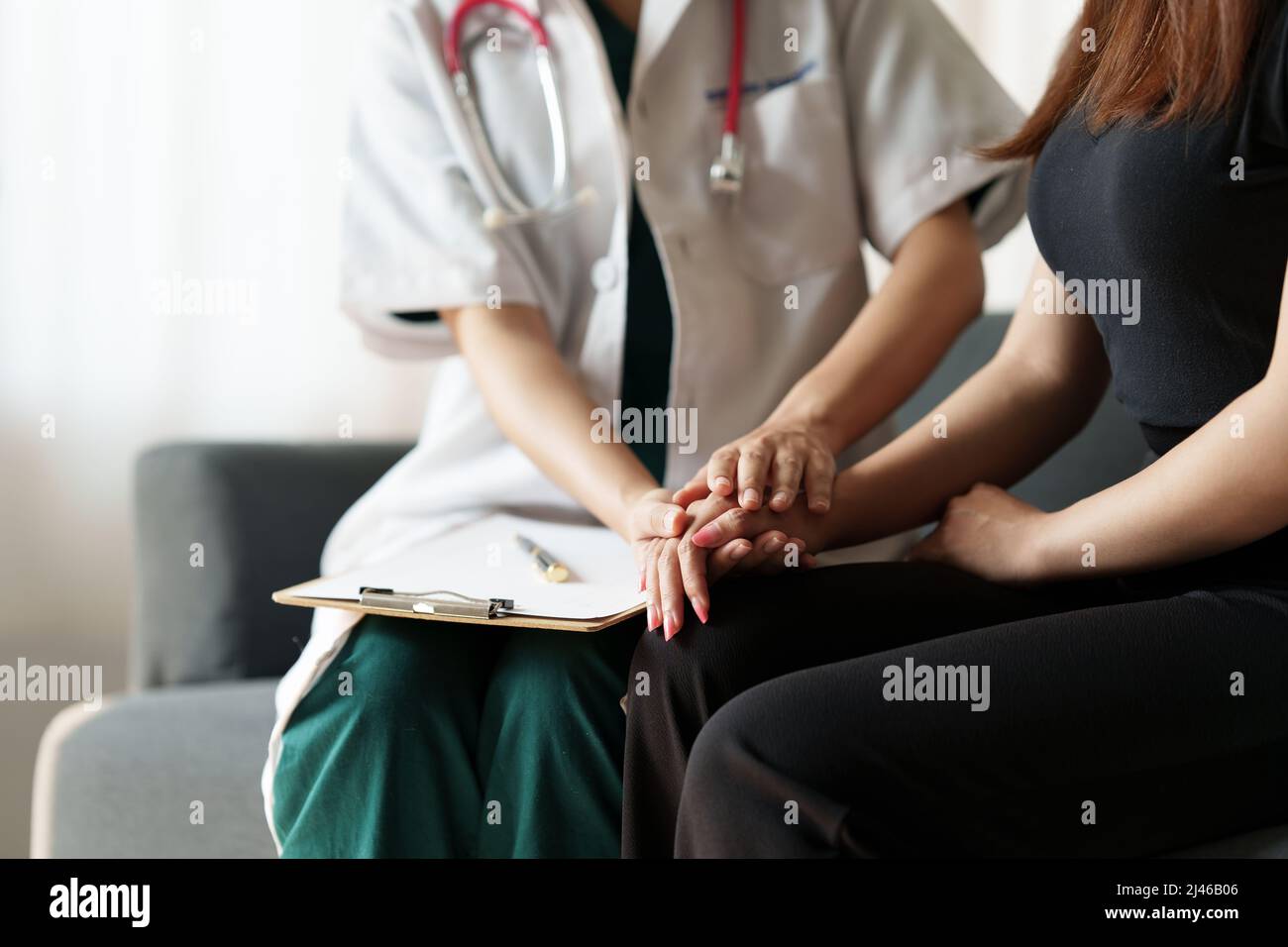 Doctor hold hand of patient and giving consolation and consultation at ...