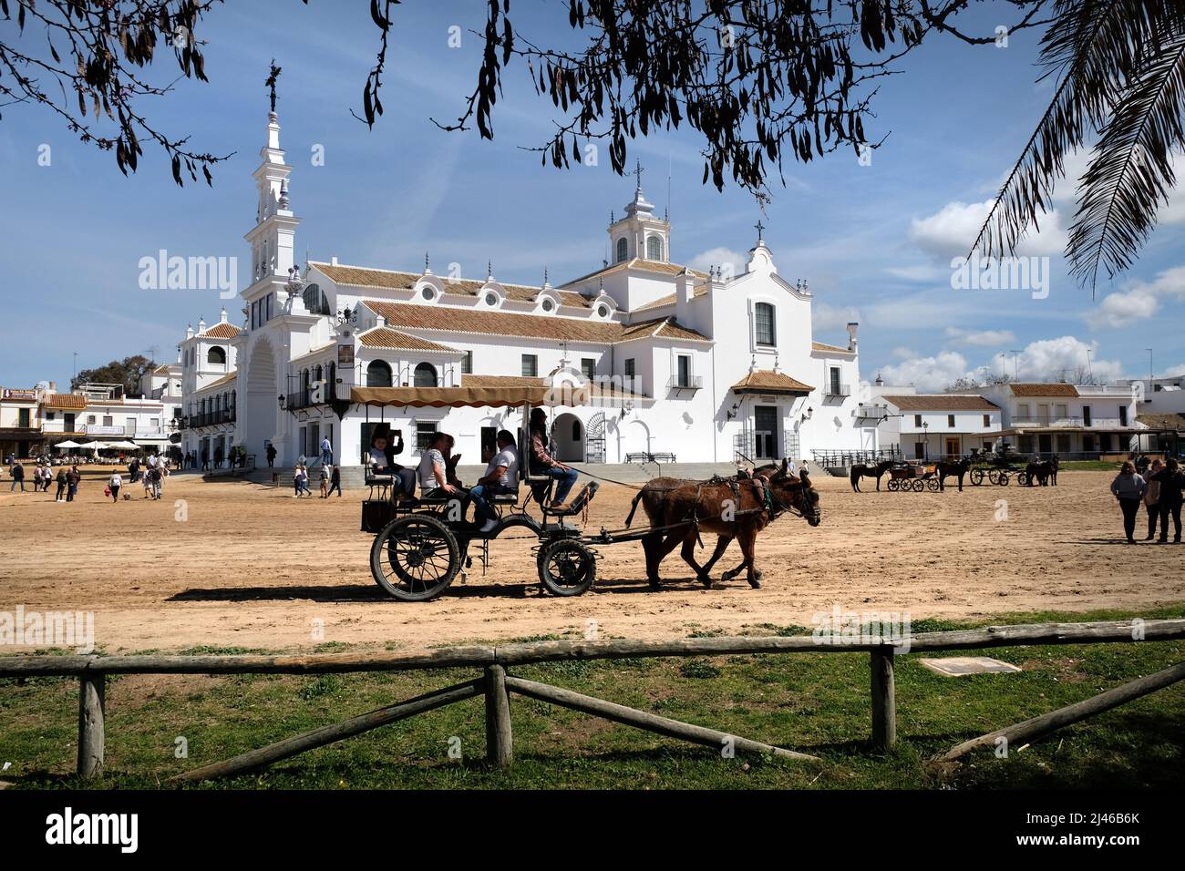 Tourist mule carriage passes Hermitage of El Rocío - Ermita de El Rocío ...