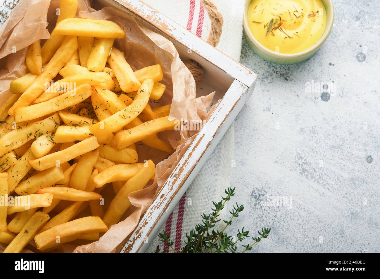 French fries. Tasty French fries server on parchment paper on wooden ...