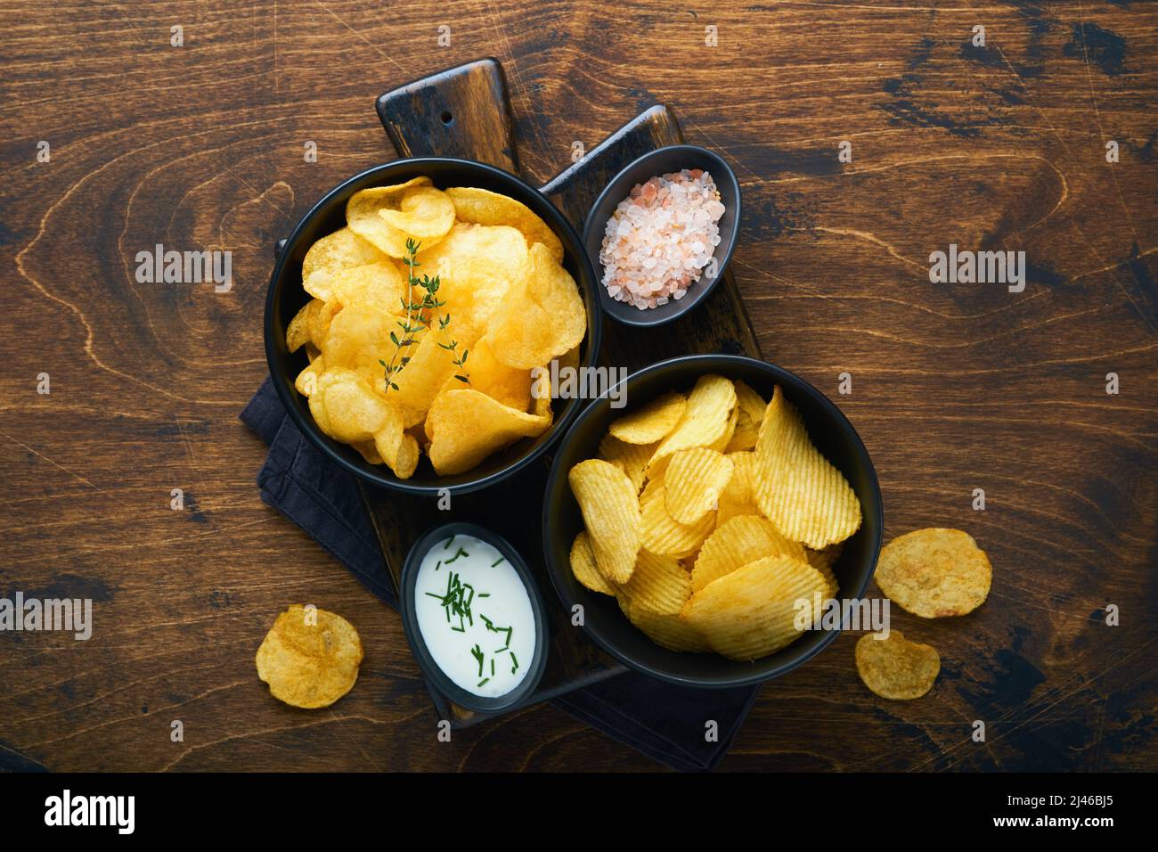 Potato chips. Fast food. Crispy potato chips ceramic black bowl with ...