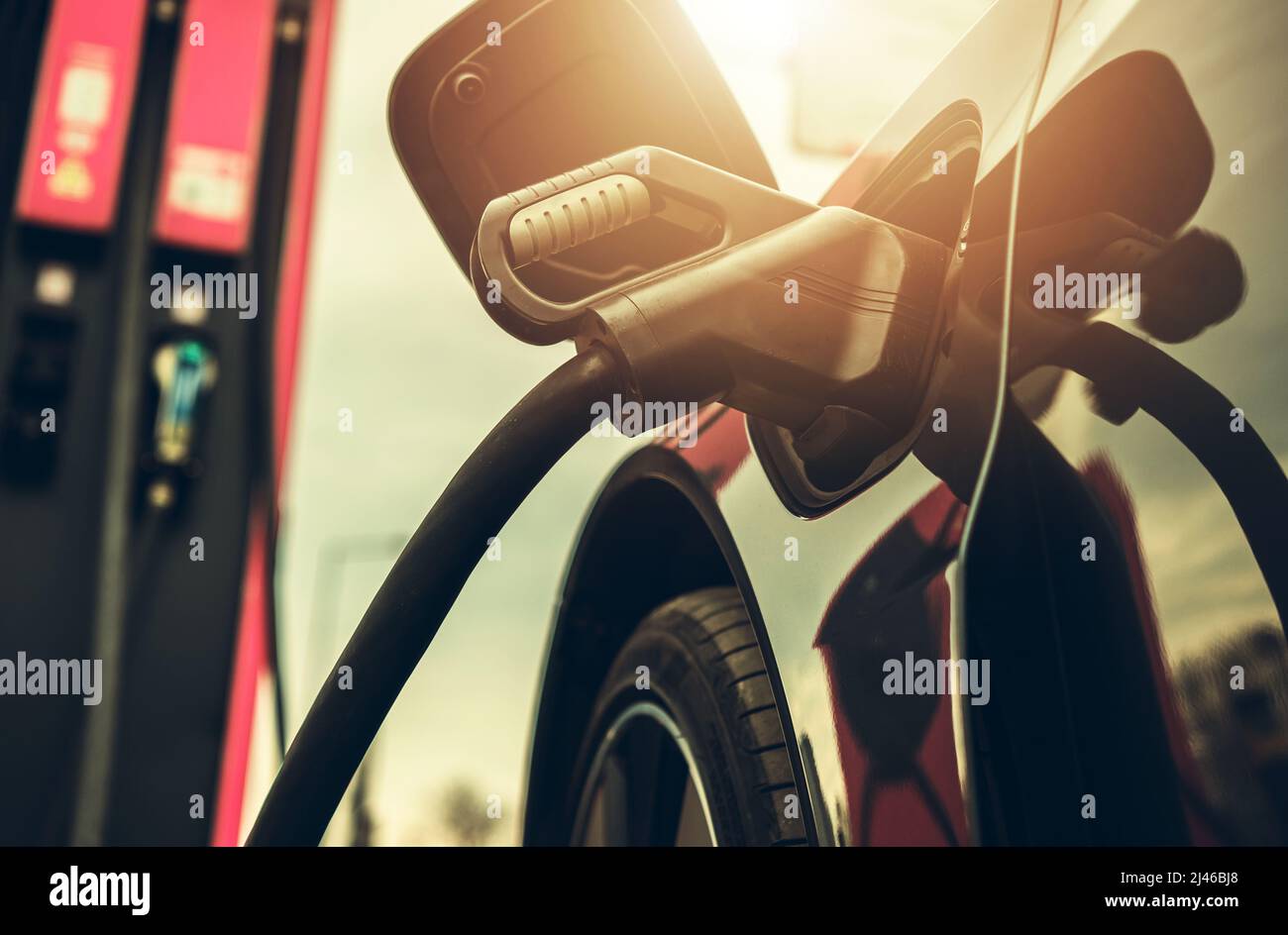 Modern Electric Car Attached to High Voltage EV Station During Charging ...