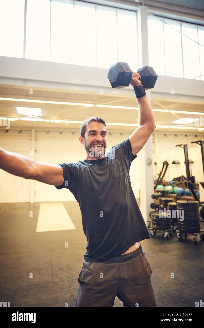 Beast mode activated. Cropped shot of a handsome young man working out ...