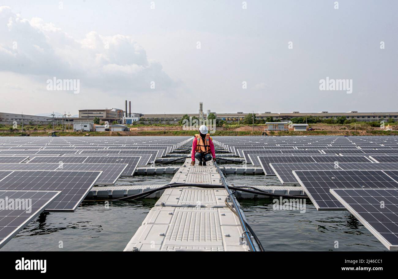 Rayong, Thailand. 11th Apr, 2022. A staff member checks the cable of ...
