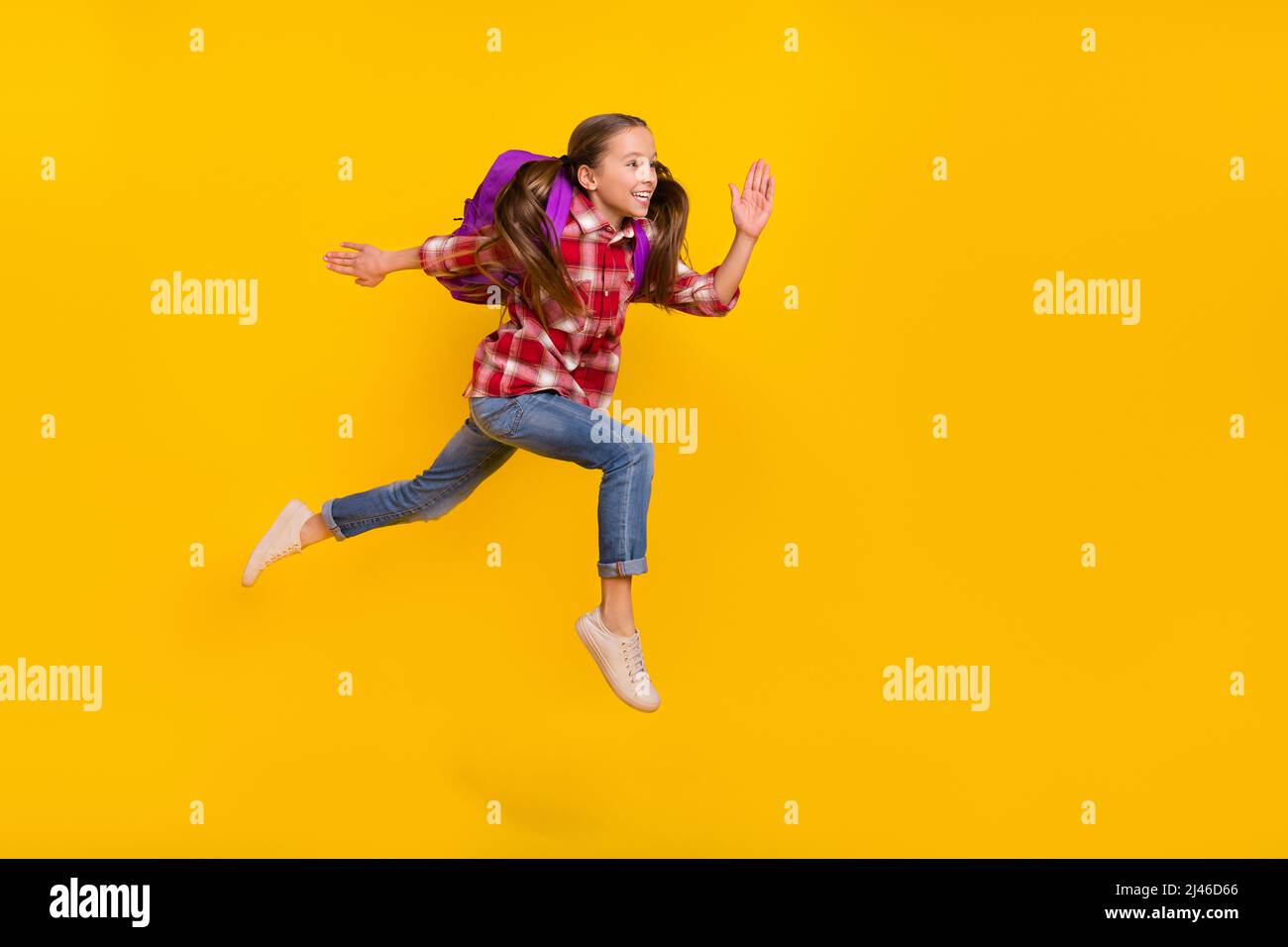 Photo of funky cute schoolgirl wear checkered shirt running fast ...