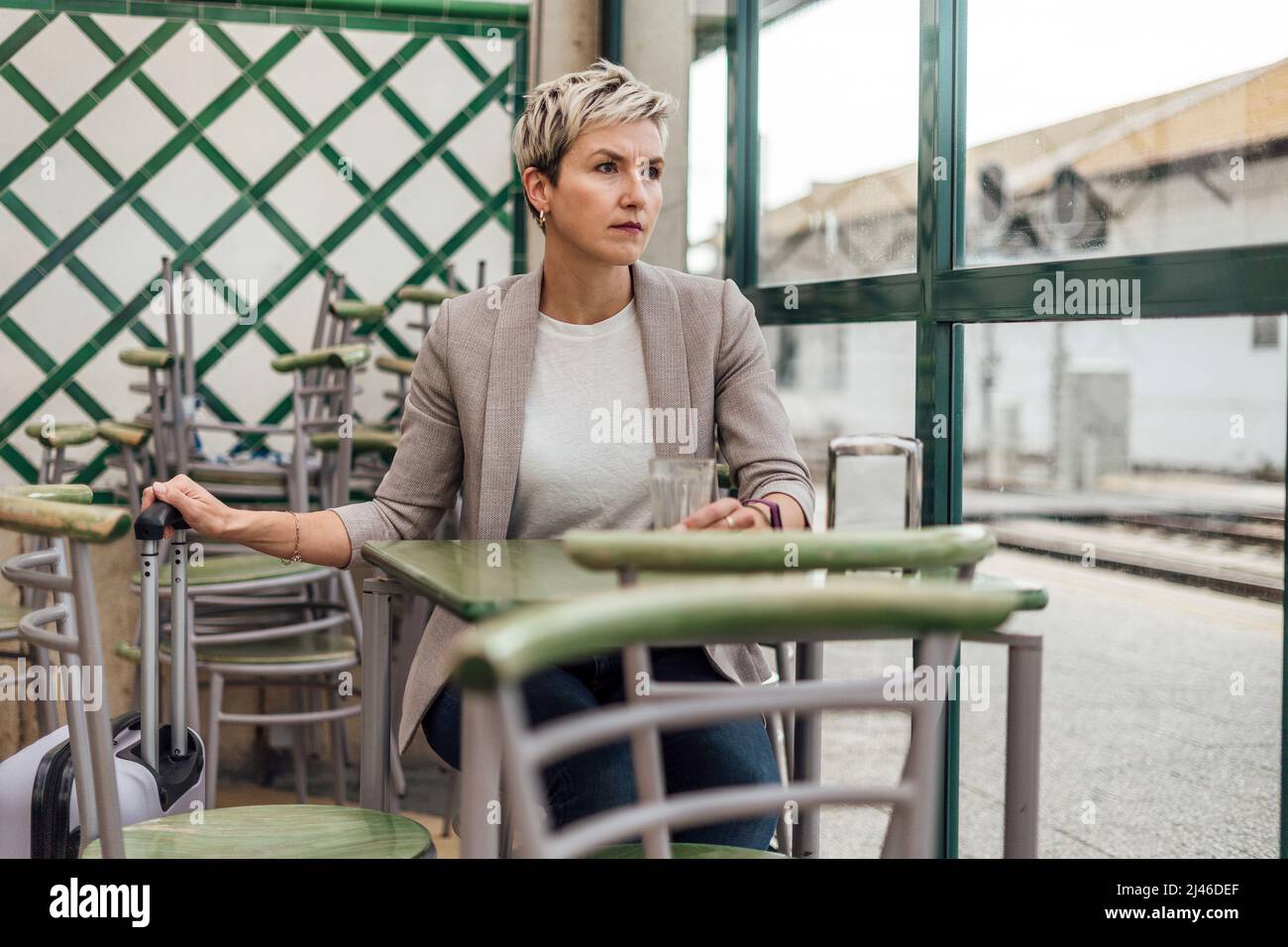 Sad thinking travelling woman waiting in a café at train station Stock ...
