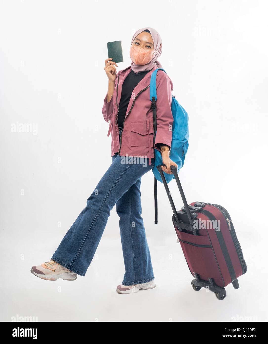 Hijab woman travelling holding passport, ticket, suitcase and carrying ...