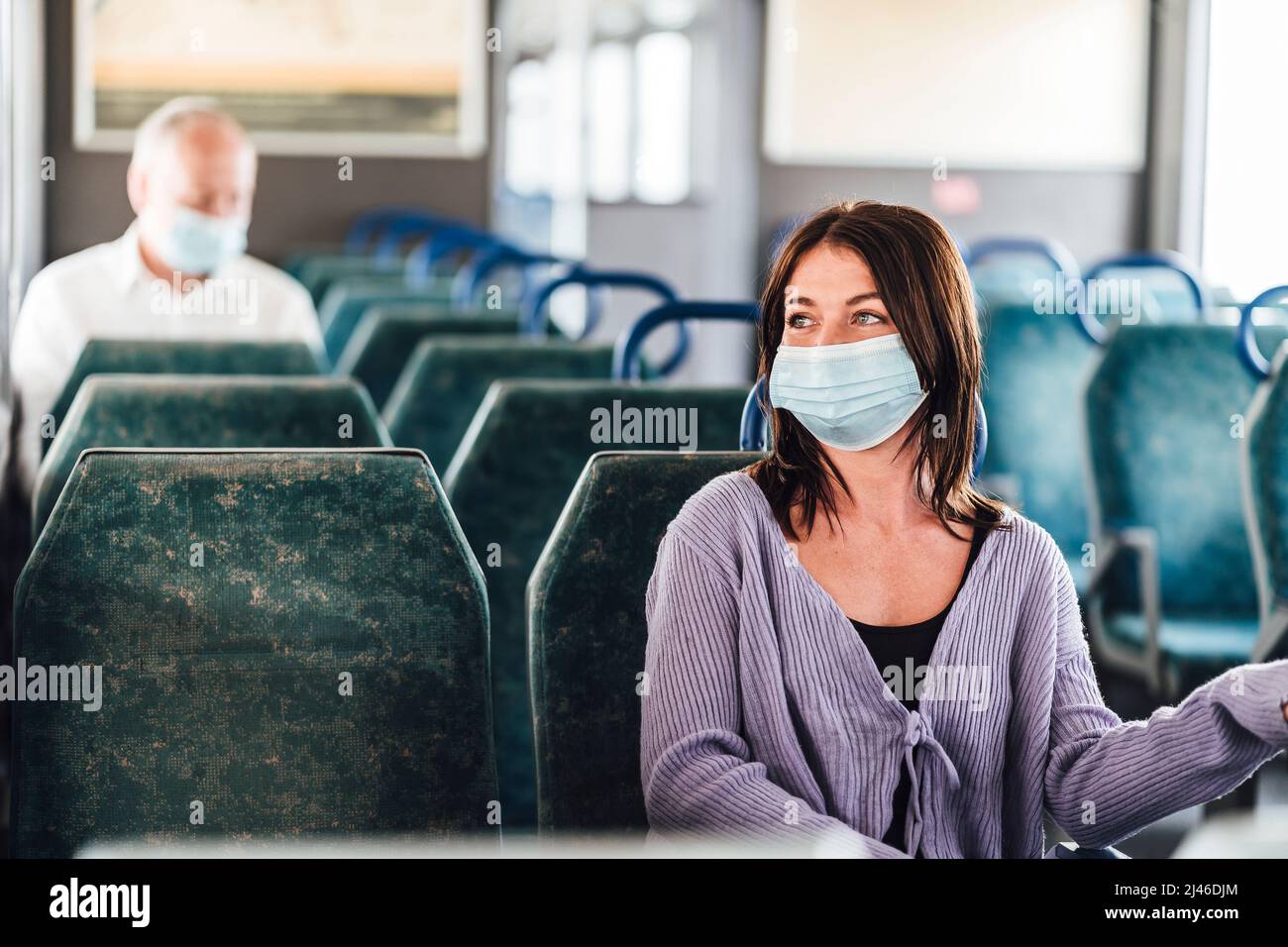 Positive commuters wearing mask enjoying their train trip Stock Photo ...