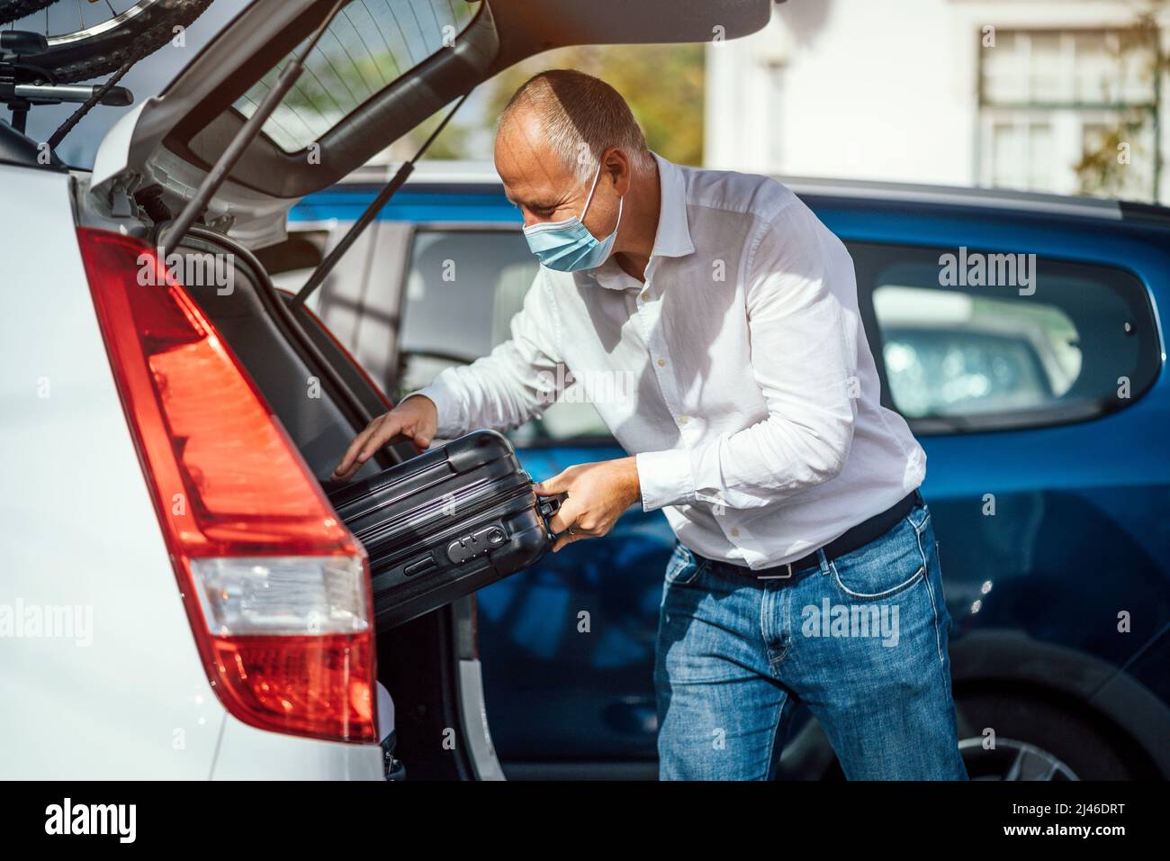 Man puts mask hi-res stock photography and images - Alamy
