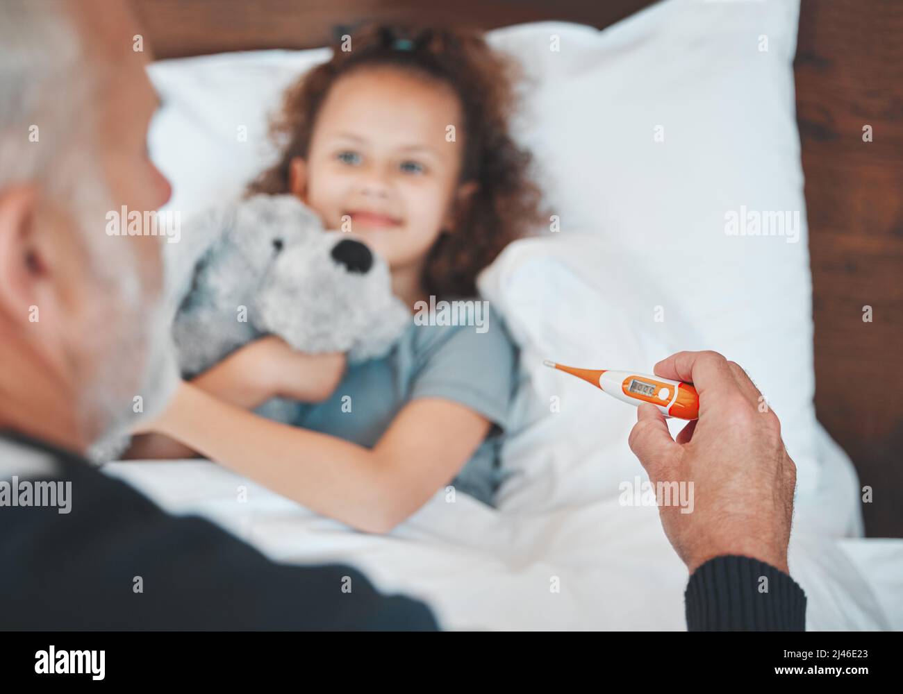 Do you have a fever. Shot of a doctor checking a sick little girls ...