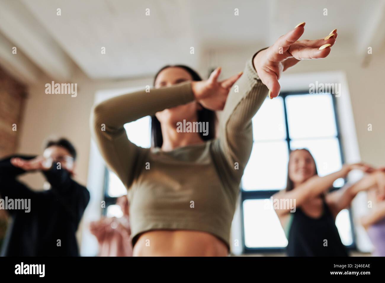 Hands of dynamic teenage girl stretching arms during vogue dance ...