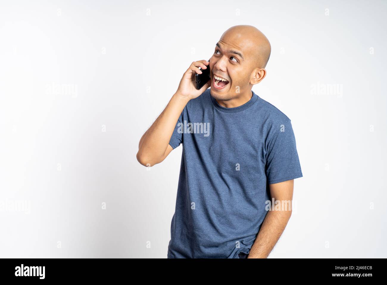 bald man laughing while making phone call Stock Photo - Alamy