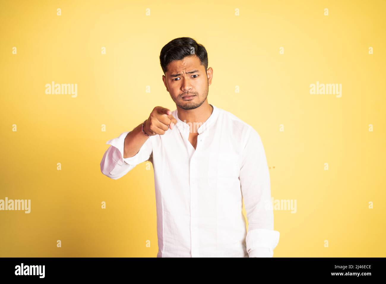 angry asian young man with finger pointing at camera Stock Photo - Alamy