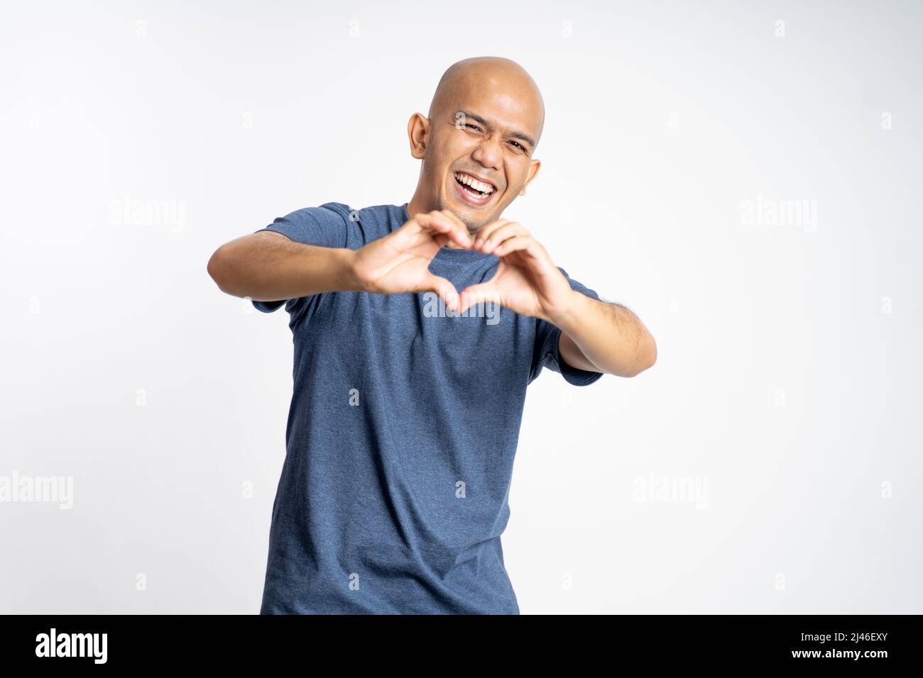 bald man forming a heart with finger gestures Stock Photo - Alamy