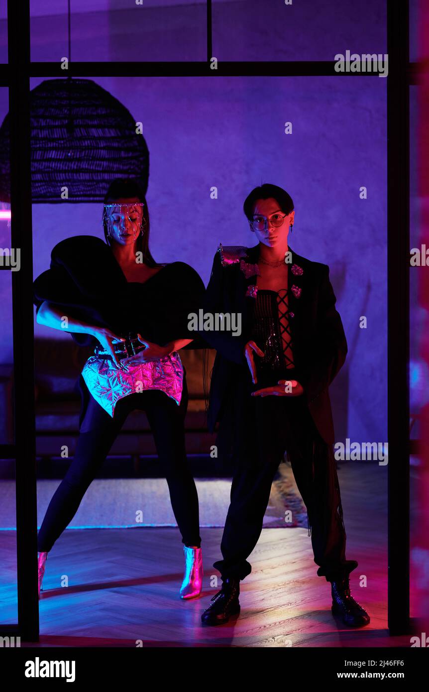 Youthful couple in posh stage costumes standing by the door of studio ...