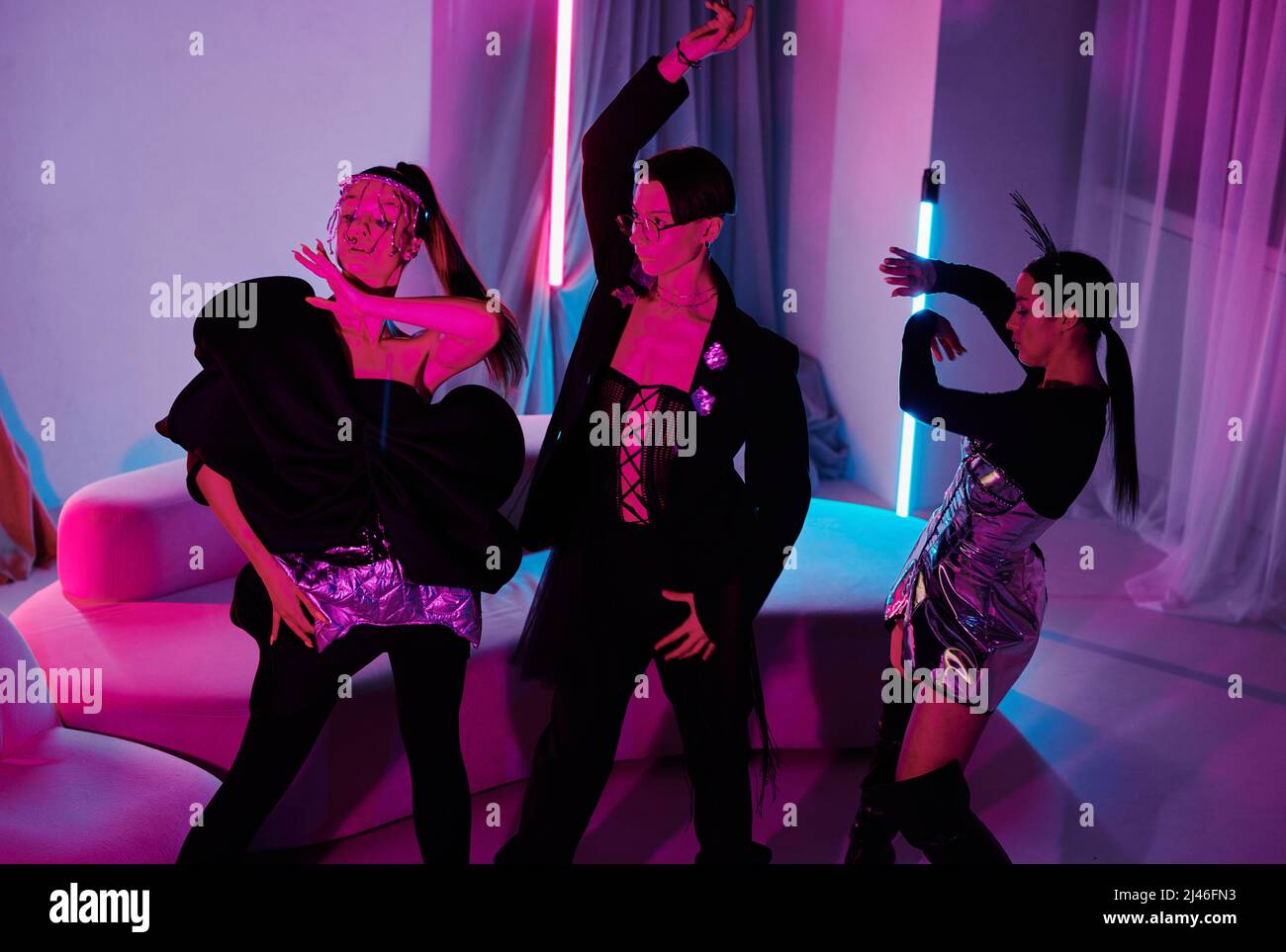 Group of posh contemporary teenage girls and guy enjoying vogue ball ...