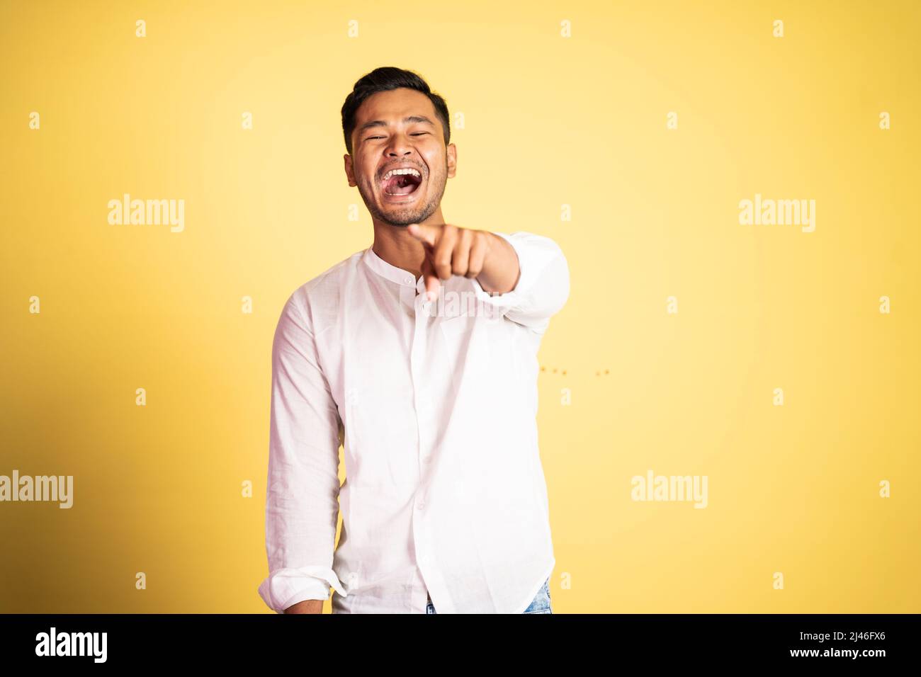 asian young man laughing with finger pointing hand gesture Stock Photo ...