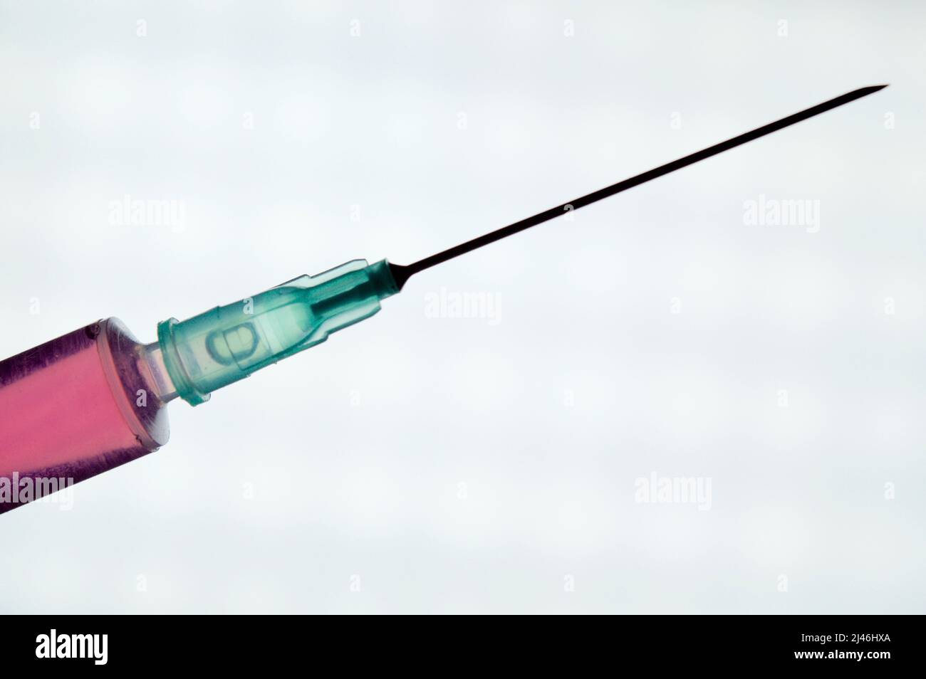 Disposable syringe against the light with red medicinal liquid Stock ...