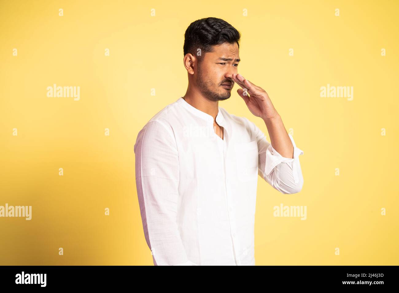 young man with disappointed waving hand in front of nose Stock Photo ...
