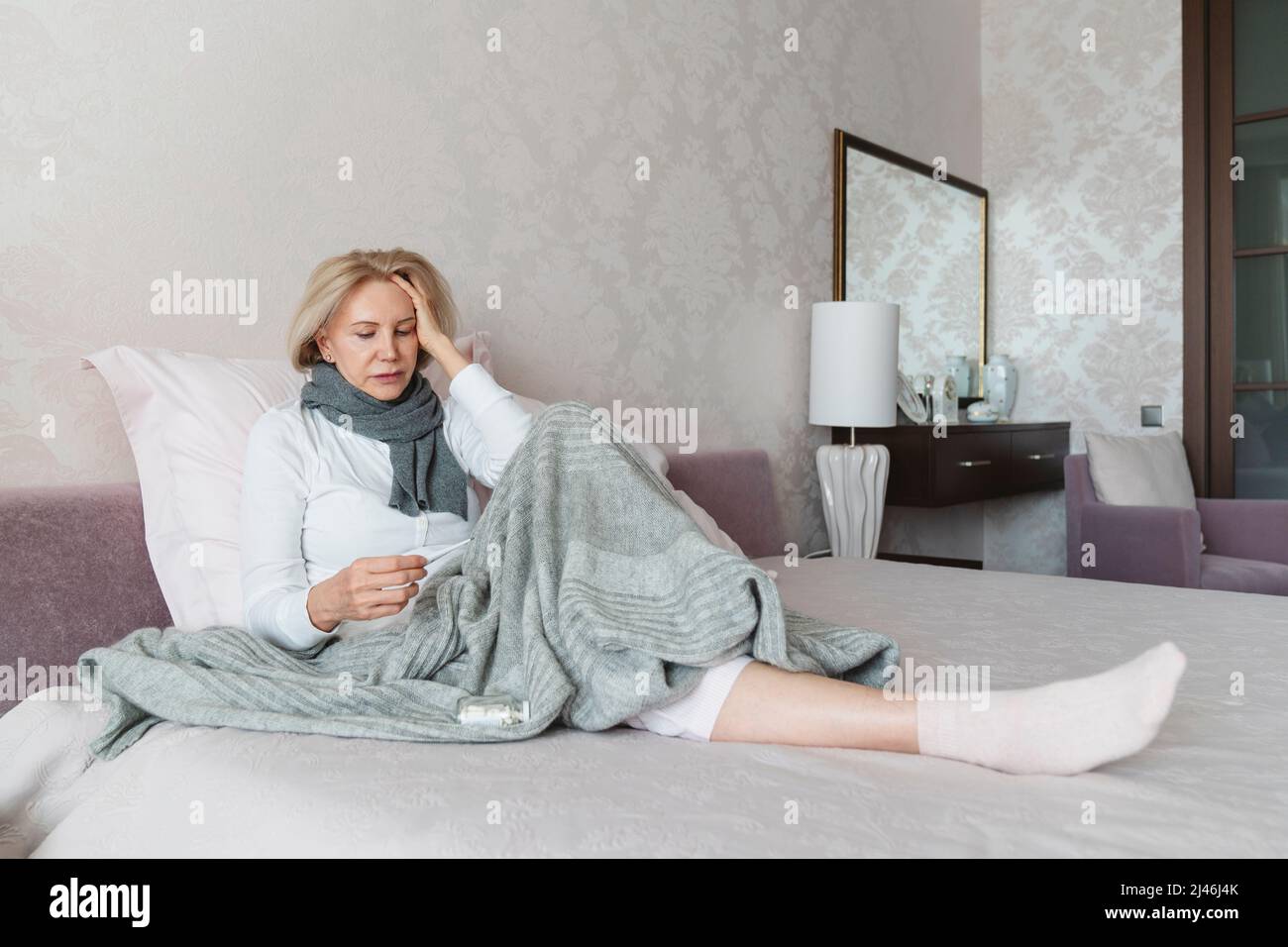 A woman is sick at home in a bed Stock Photo - Alamy