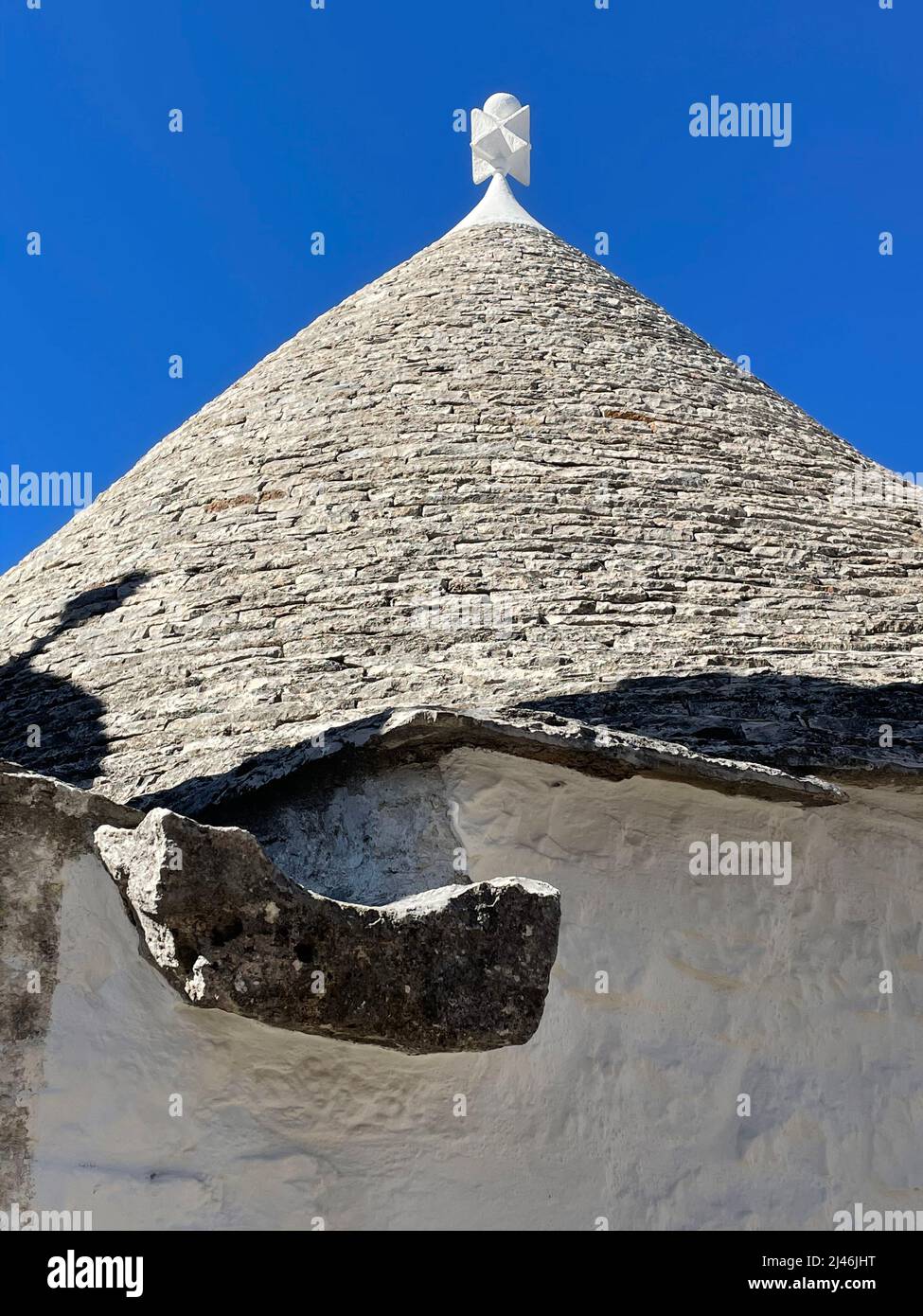 The conic roof, with pinnacle, of a 500-year-old traditional trullo ...