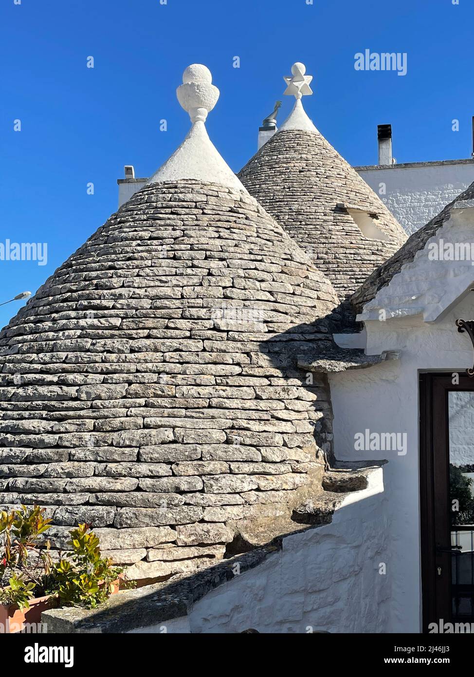 The conic roofs, with pinnacle, of 500-year-old traditional trulli rock ...